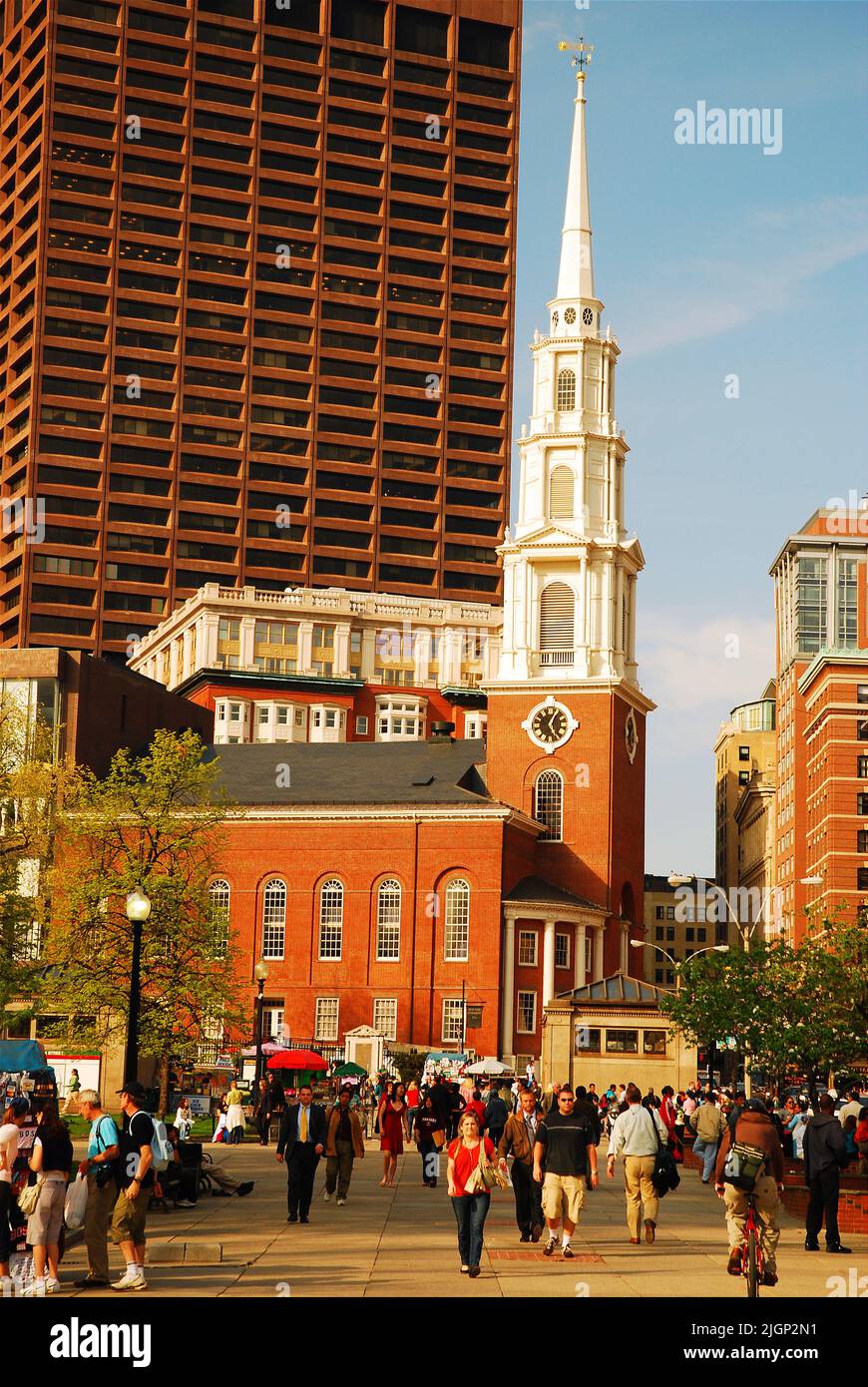 Commuters and tourist walk the sidewalk in front of Boston Common with ...