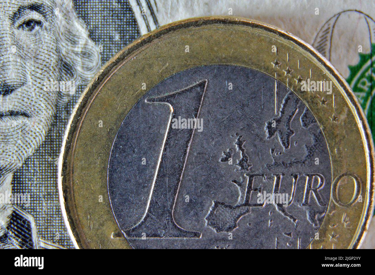 In this photo illustration, a one euro coin is seen on top of a one ...