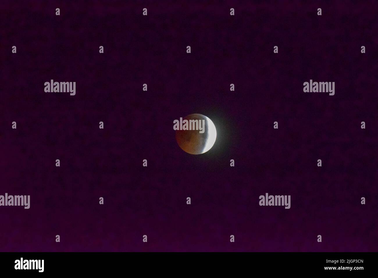 Blood moon starting to escape full eclipse Stock Photo - Alamy