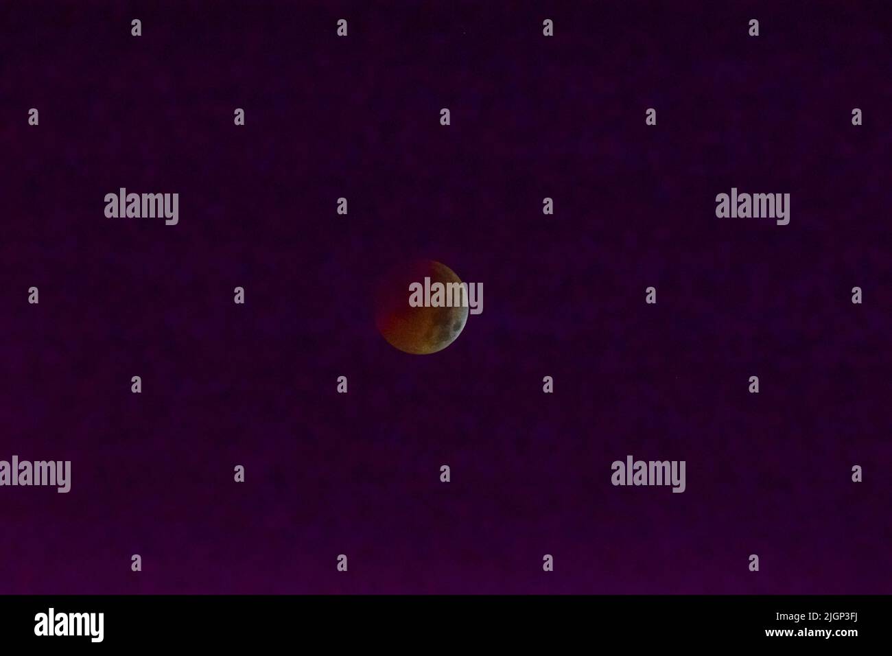 Blood moon starting to escape full eclipse Stock Photo - Alamy