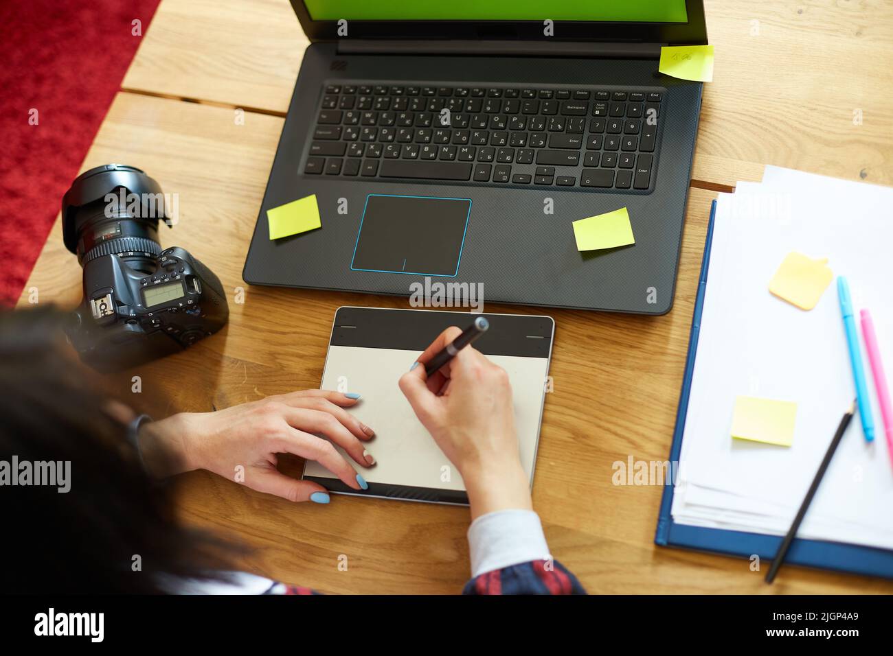 Creative female photographer, using graphic drawing tablet and stylus ...