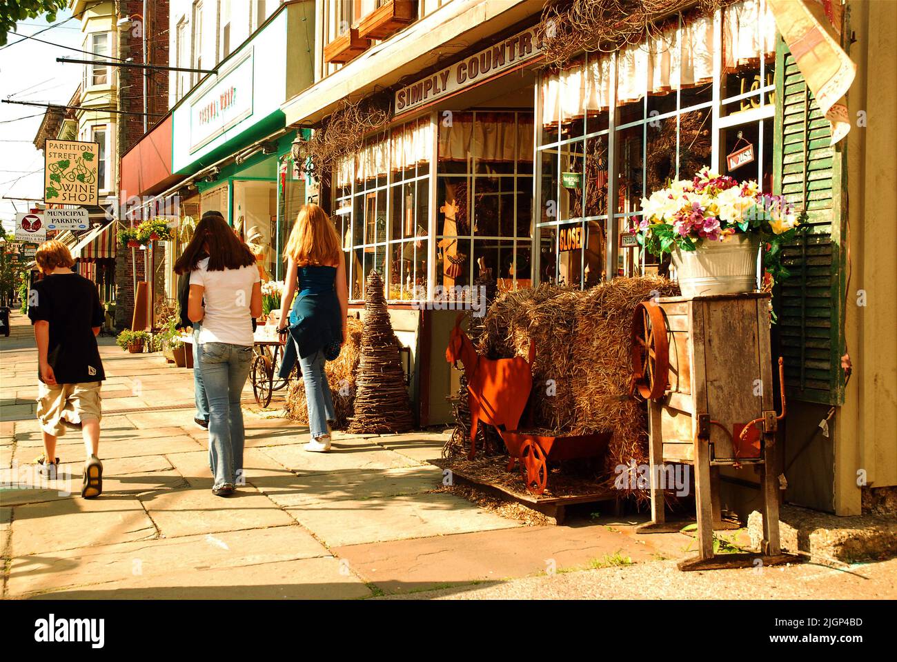 A group of teenagers walk through the historic small town downtown ...