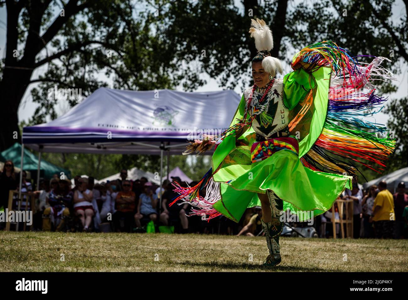 A pow-wow participant doing a traditional dance in the arena during the ...