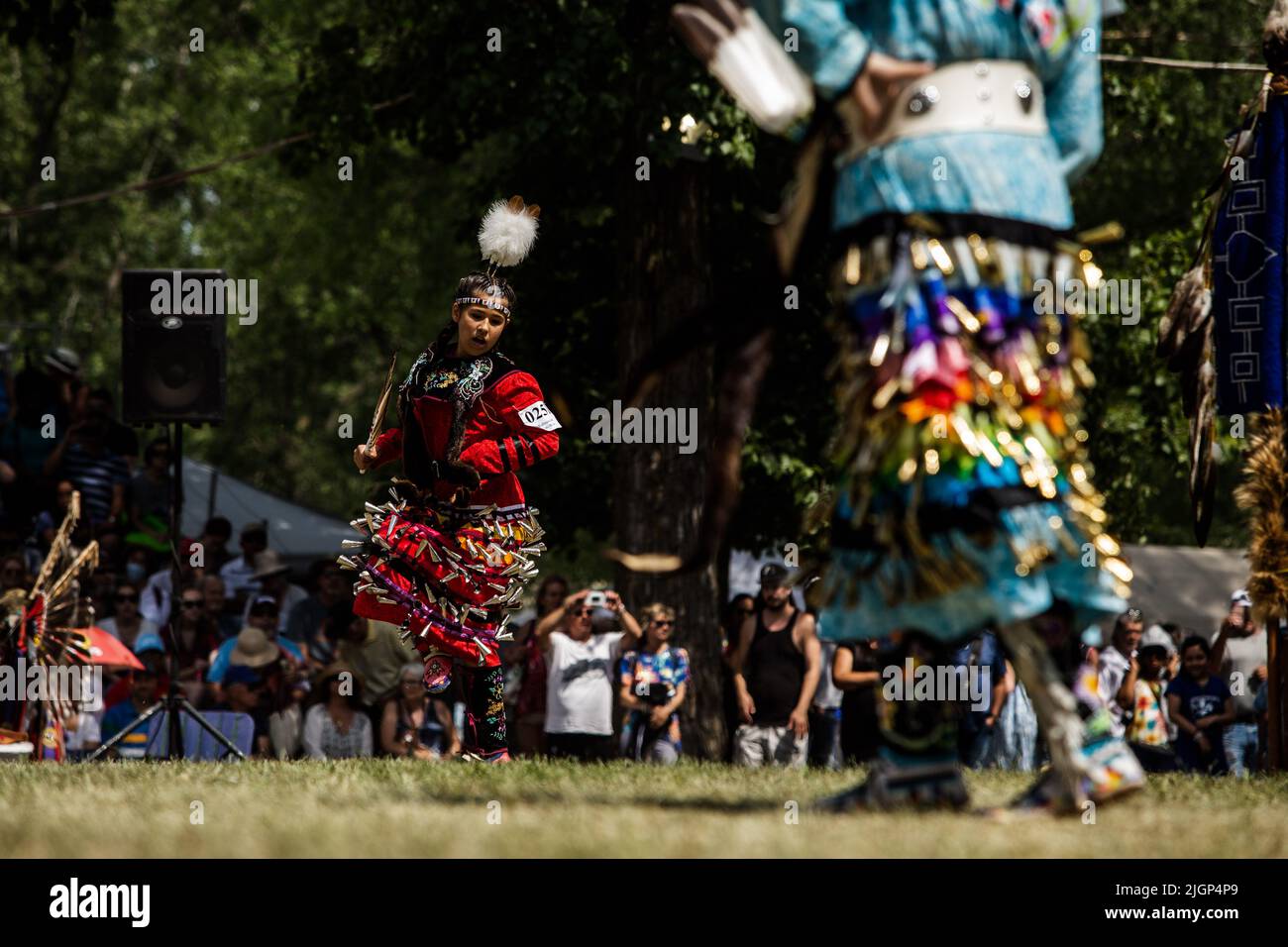 A pow-wow dancer doing a traditional dance in the arena during the ...