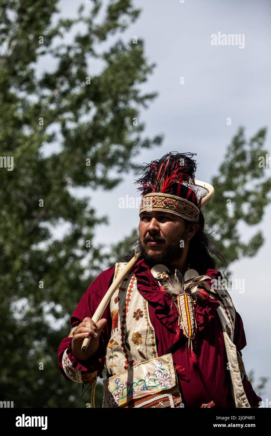 A pow-wow dancer doing a traditional dance in the arena during the ...