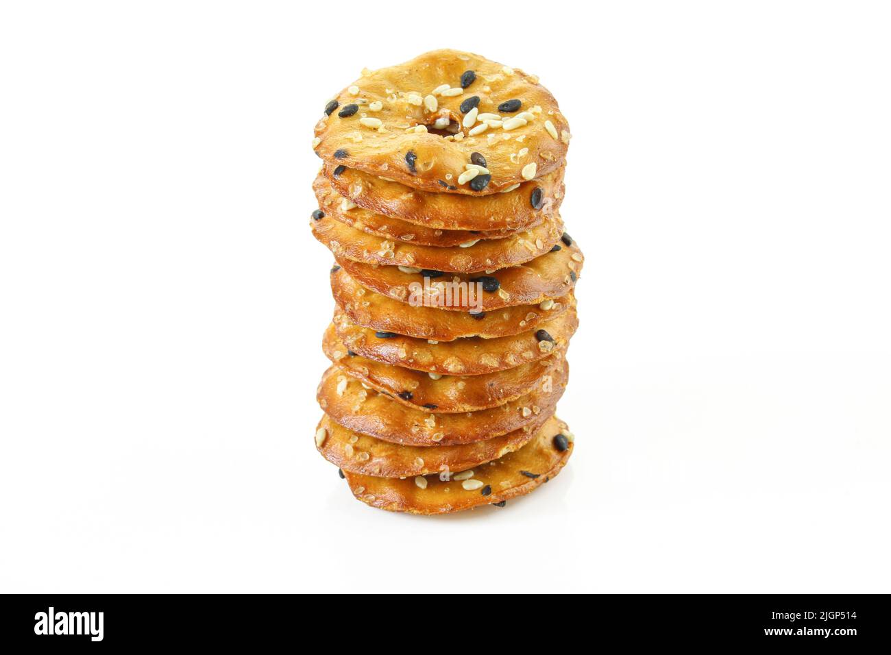 Stack of thin cracker chips with seeds isolated on white background ...