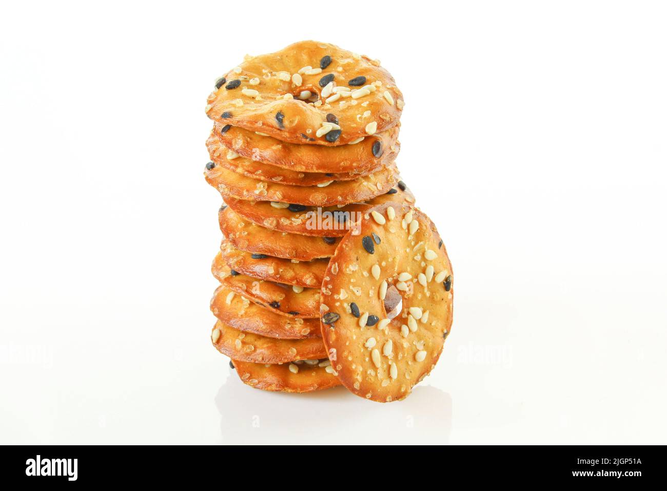 Stack of thin cracker chips with seeds isolated on white background ...