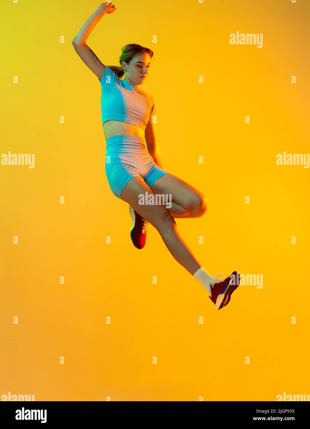Professional longjumper. One female athlete in sports uniform jumping ...