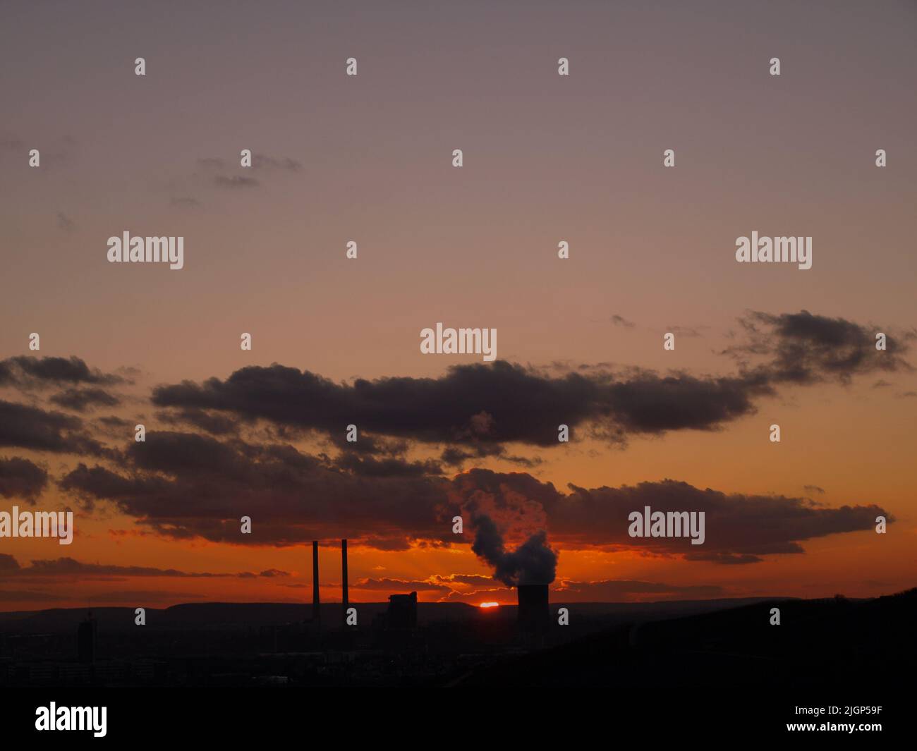 crisp red orange sunset in a dramatic clouds sky formation and a ...