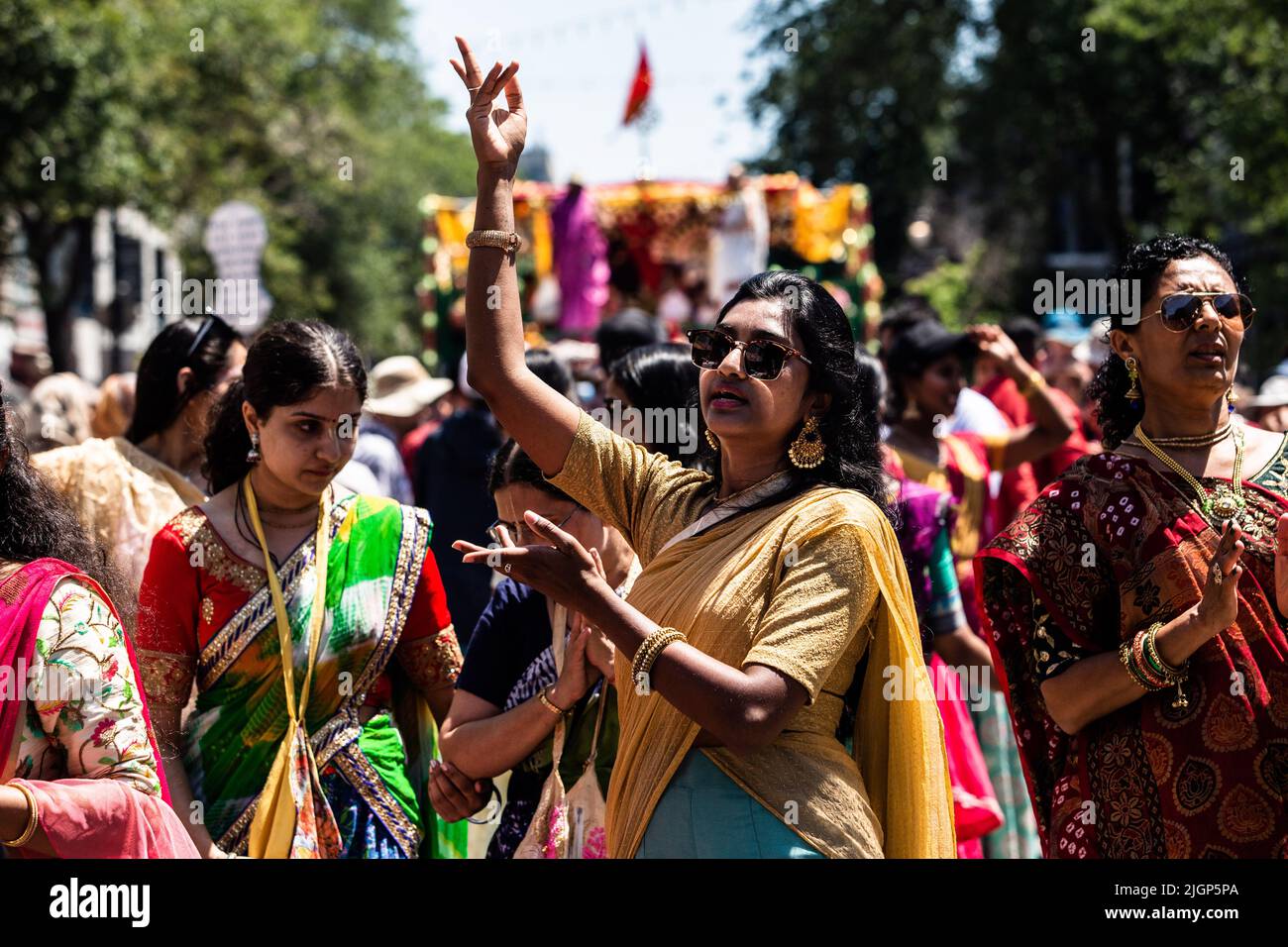 Devotees dance following the main float cart during the celebration ...
