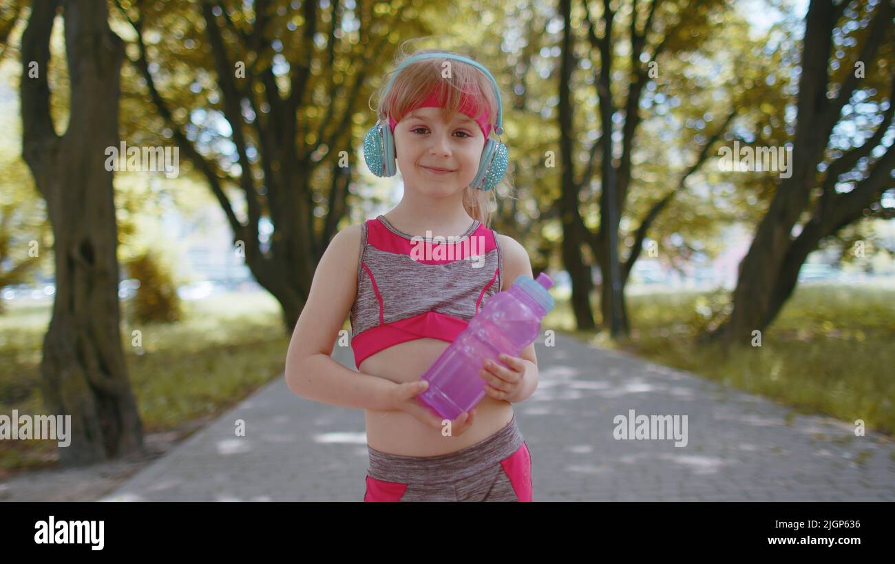 Fitness sport runner child girl wearing headphones listening favorite ...