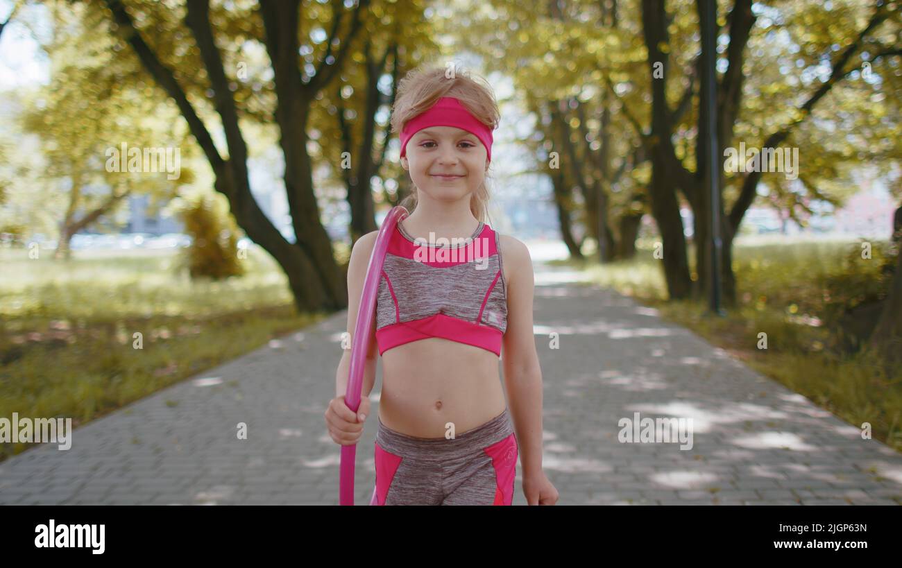 Athletic fitness toddler girl walking with Hula hoop circle ring on ...