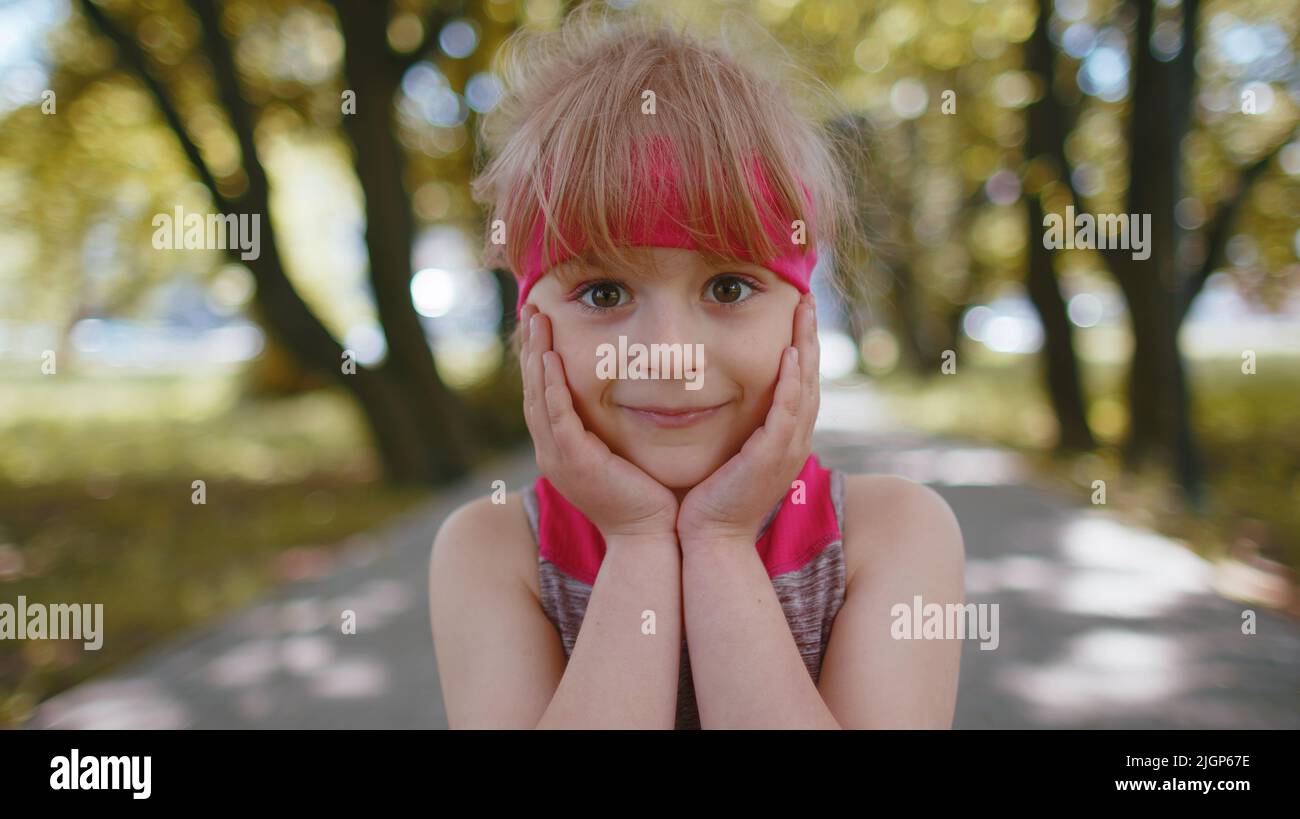 Oh my God, Wow. Athletic fitness child kid runner girl raising hands in ...