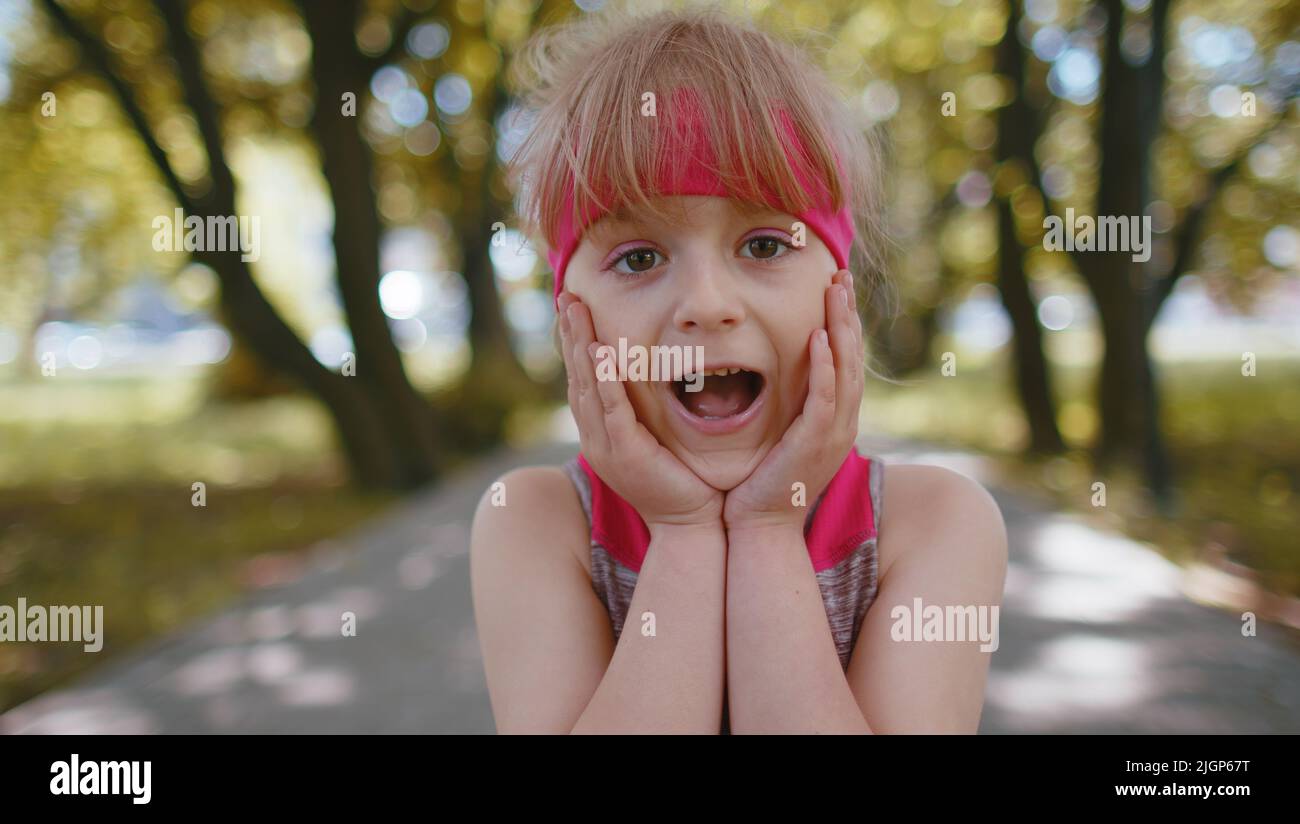 Oh my God, Wow. Athletic fitness child kid runner girl raising hands in ...