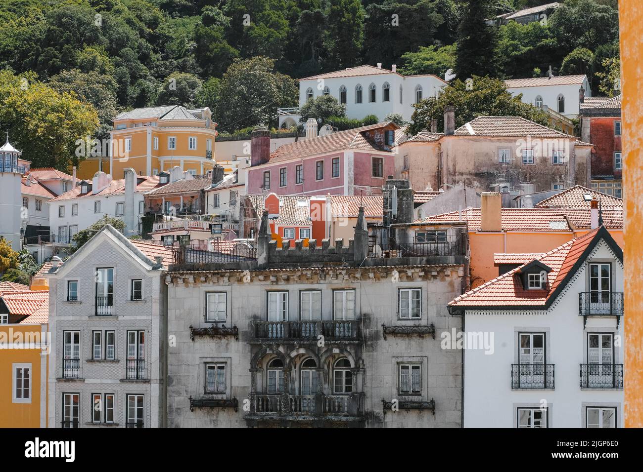 Buildings of the old city on a mountain slope in a dense green forest ...