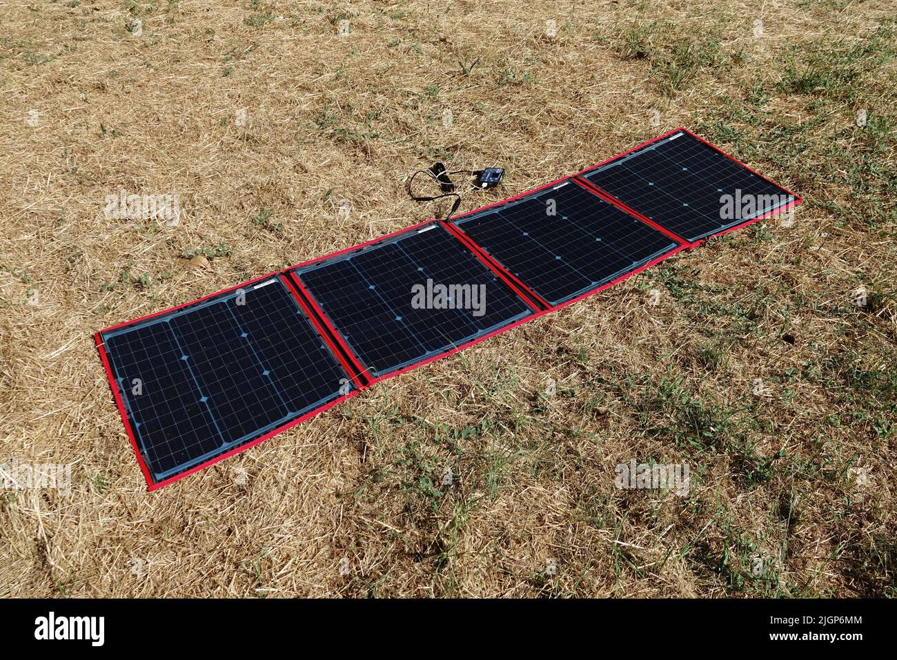 A foldable, portable solar panel open on a lawn Stock Photo - Alamy