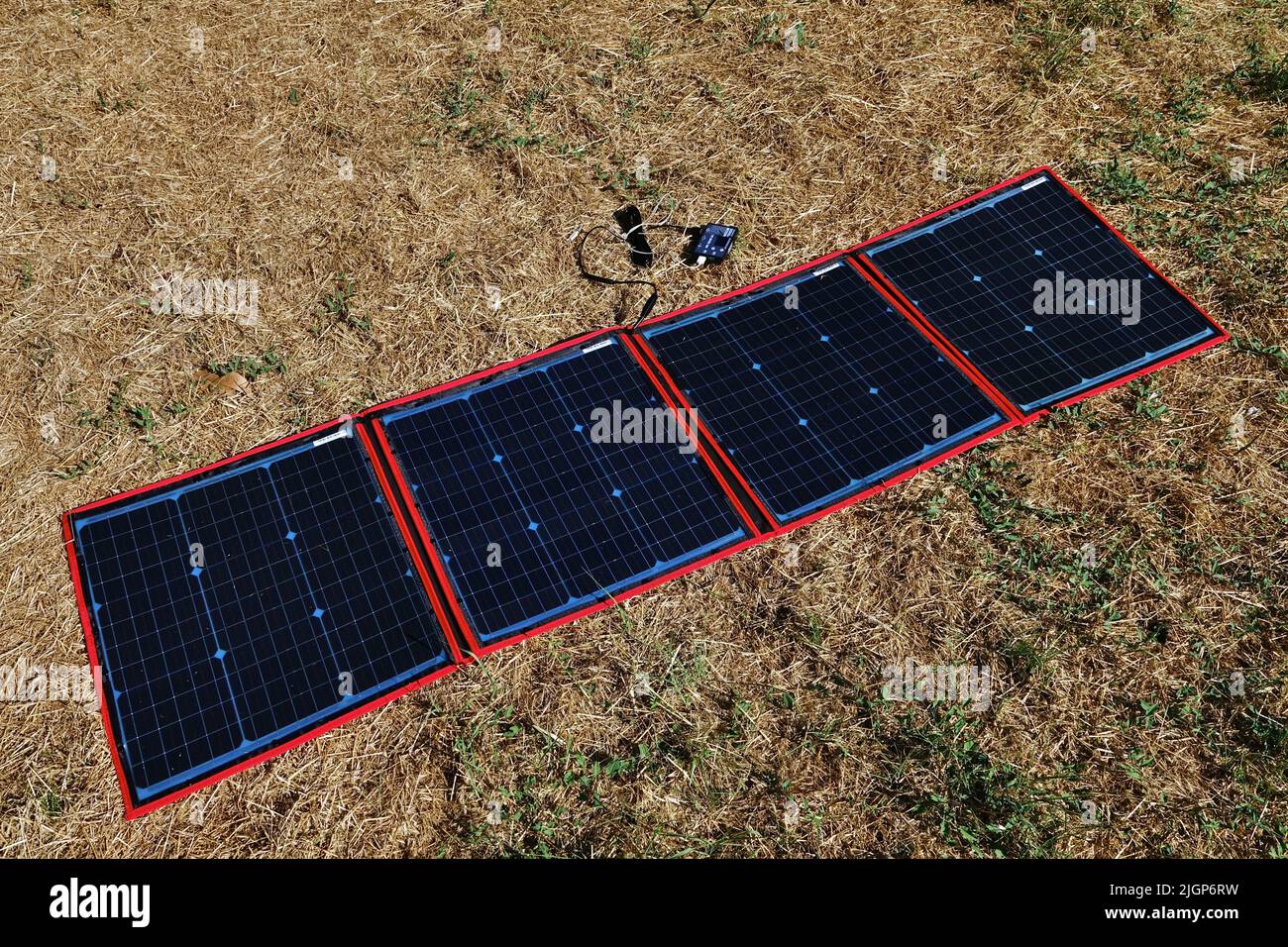 A foldable, portable solar panel open on a lawn Stock Photo - Alamy