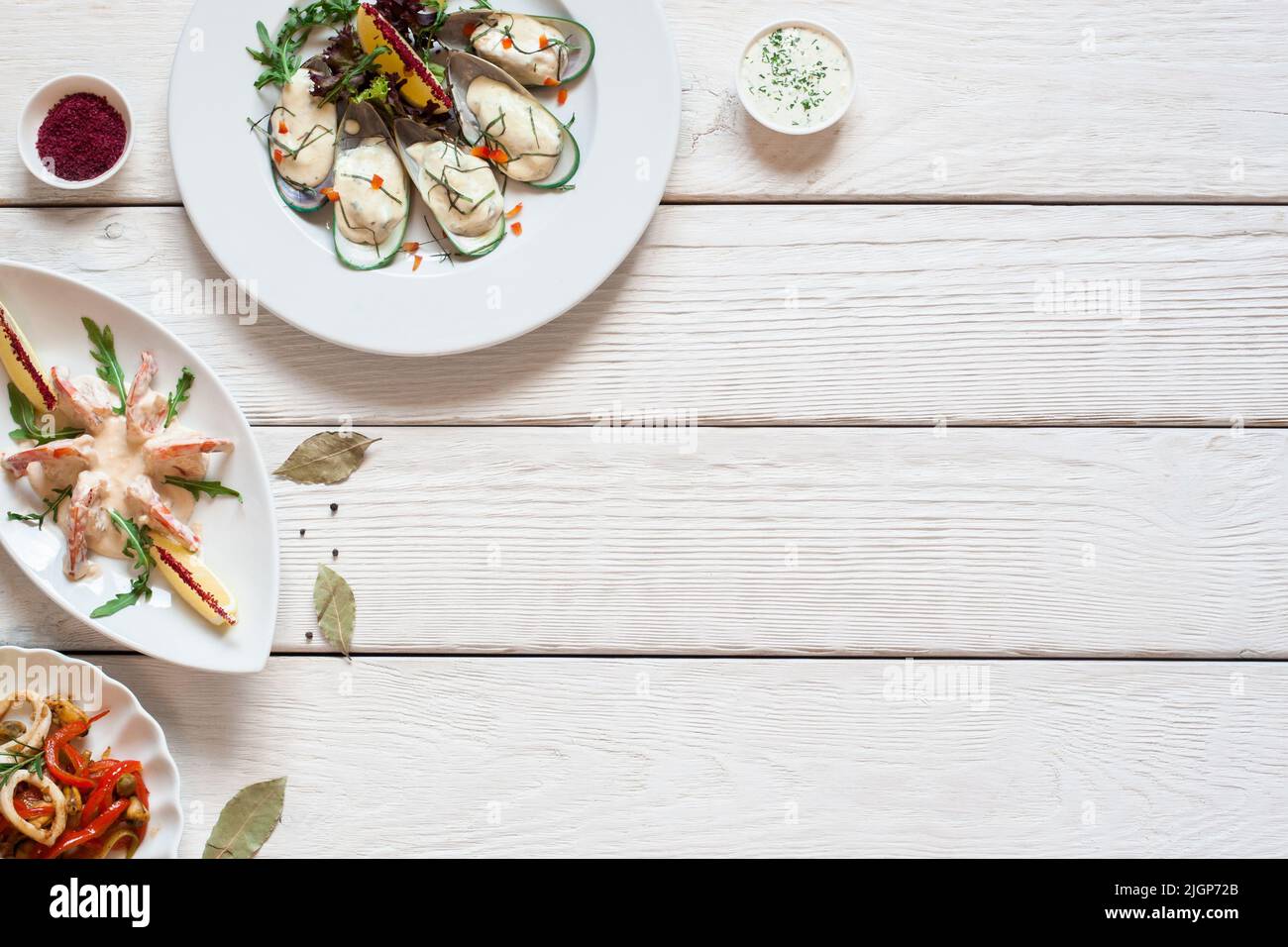 White wooden table with seafood meals flat lay Stock Photo - Alamy