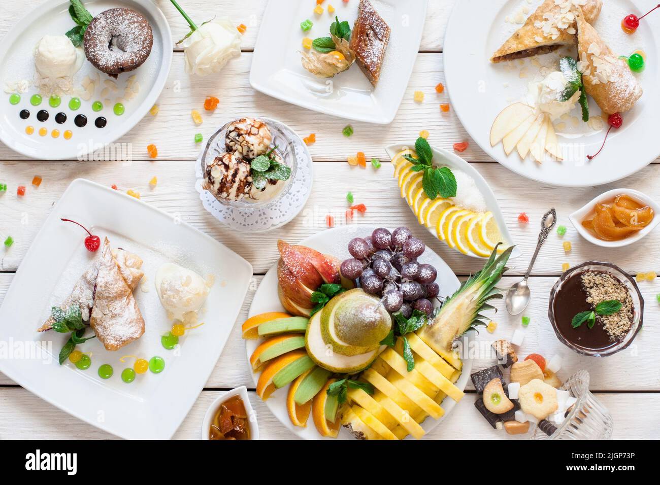 Sweet desserts with fruit assortment flat lay Stock Photo - Alamy