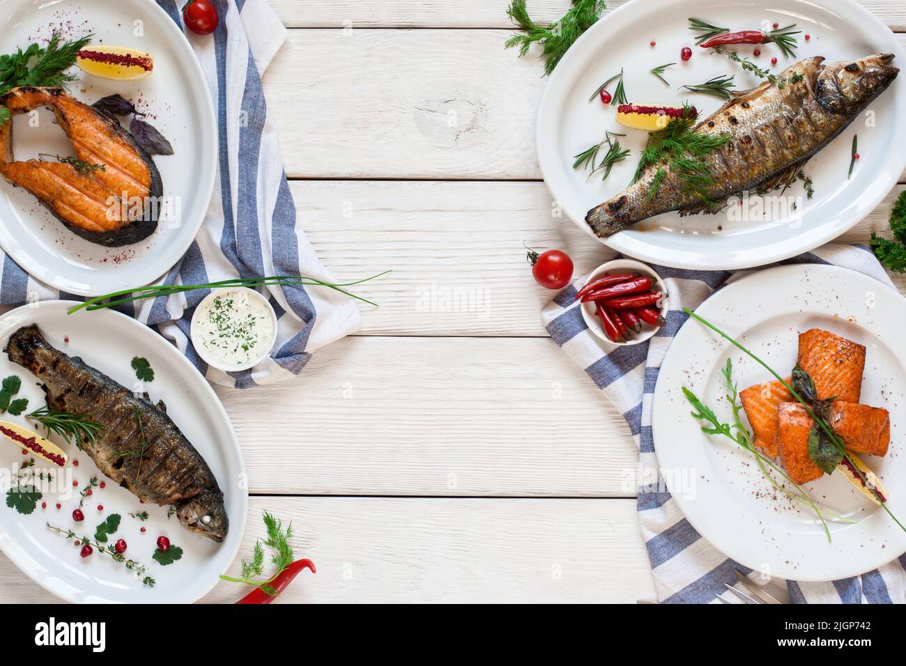 Grilled fish frame on white wooden table Stock Photo - Alamy