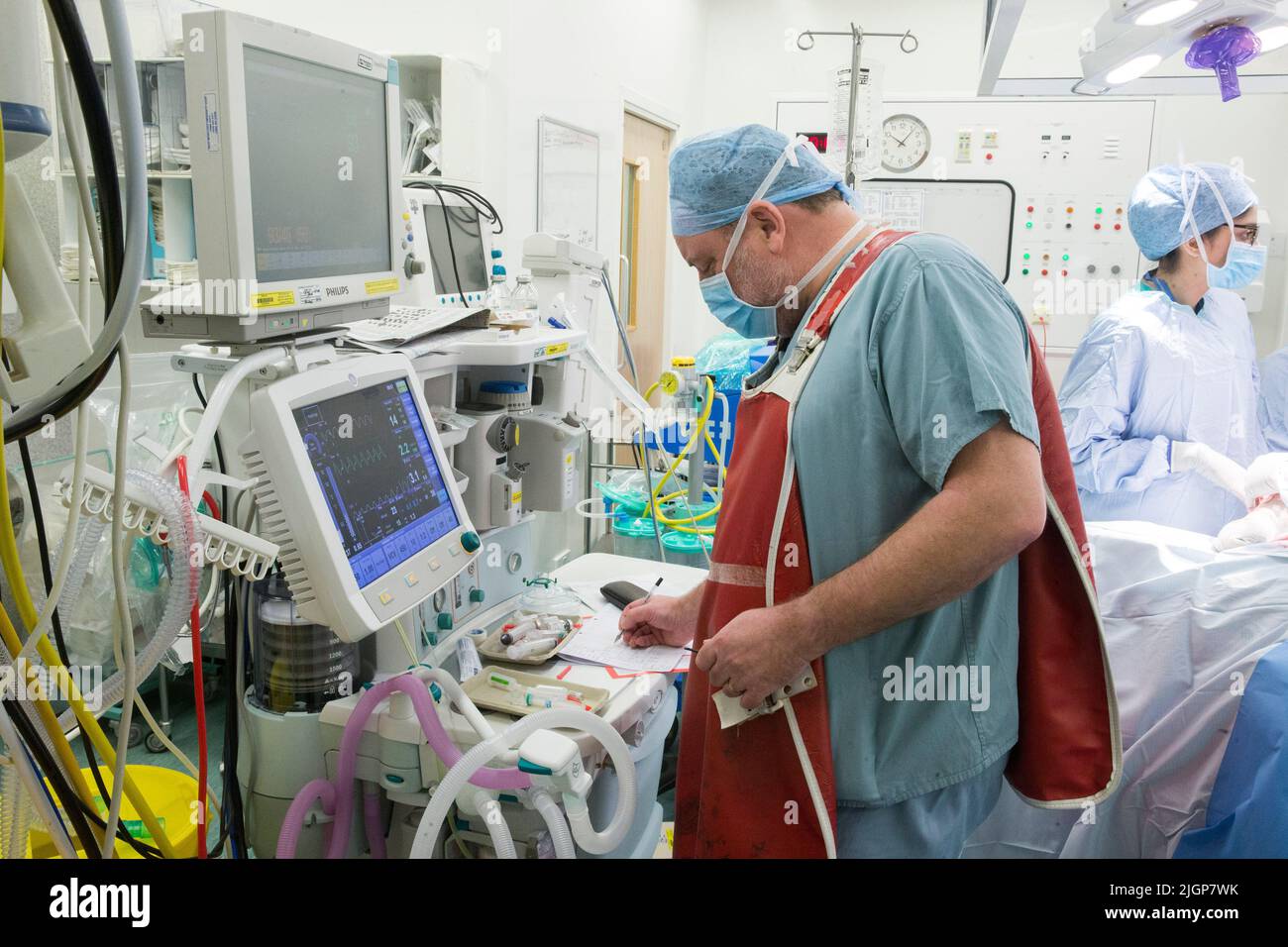 An Anaesthetist checks the patient's progress during an NHS hospital ...