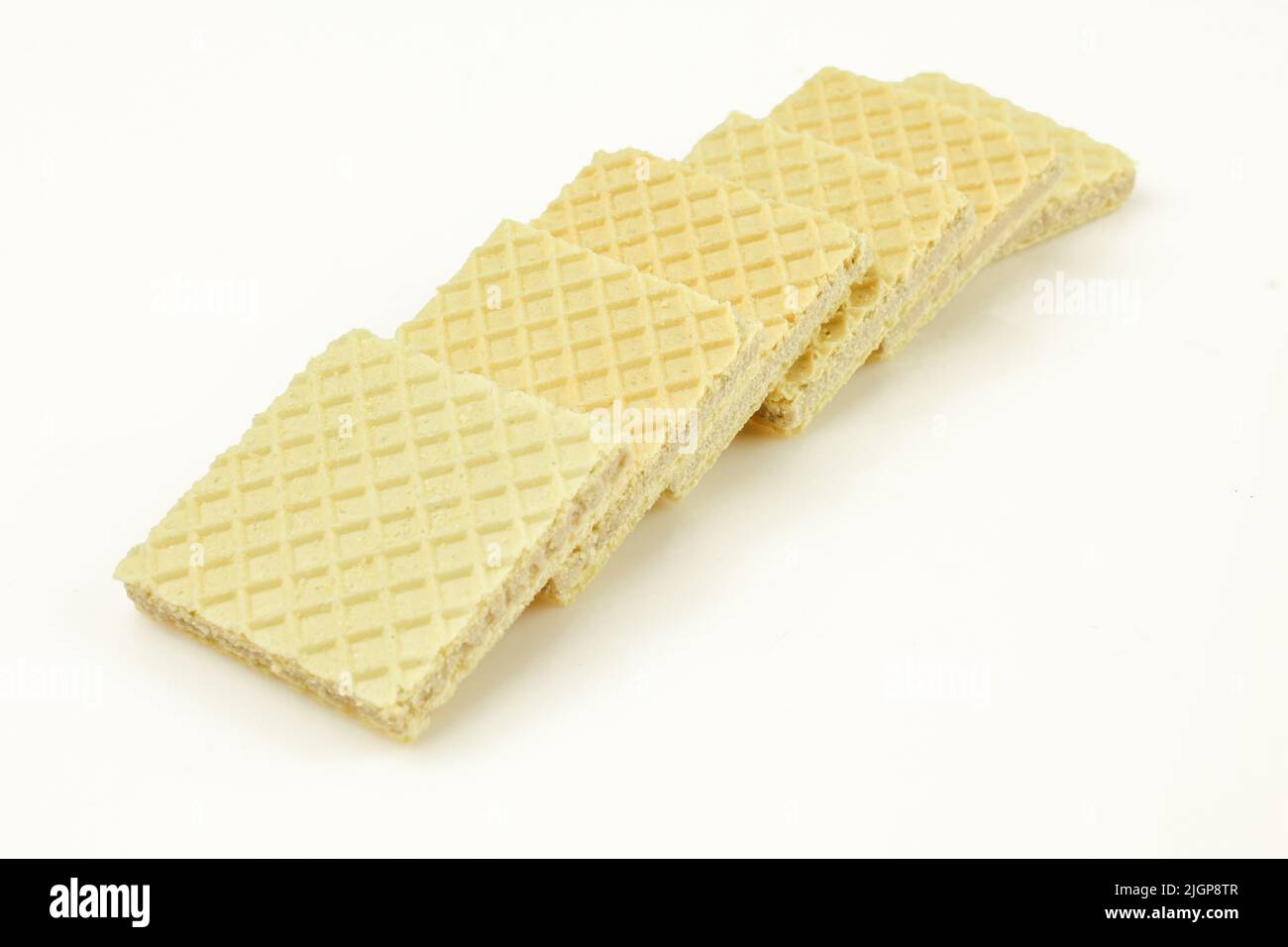 Stack of thin vanilla filled wafer biscuits isolated on white ...