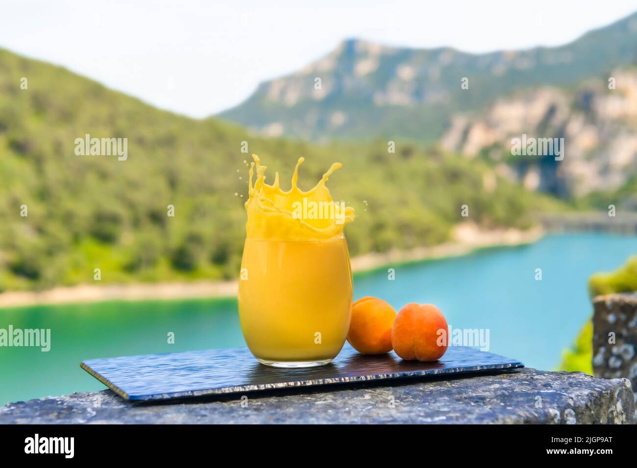 Splashing apricot juice with apricots on a tray Stock Photo - Alamy