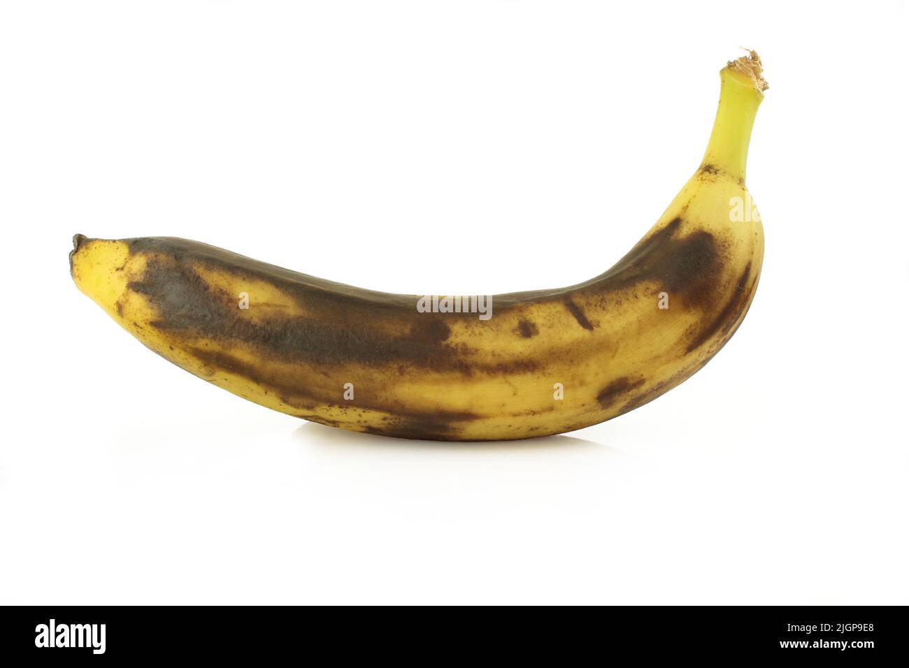 Single overripe black banana isolated on white background. Decomposing ...