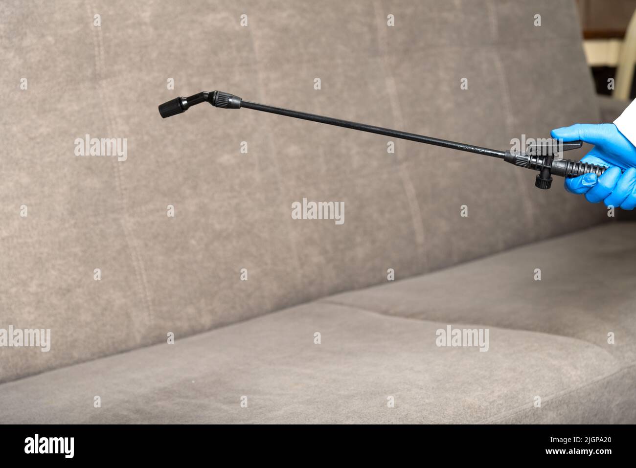 Spray gun with pesticides close-up. Fight against insects in apartments ...