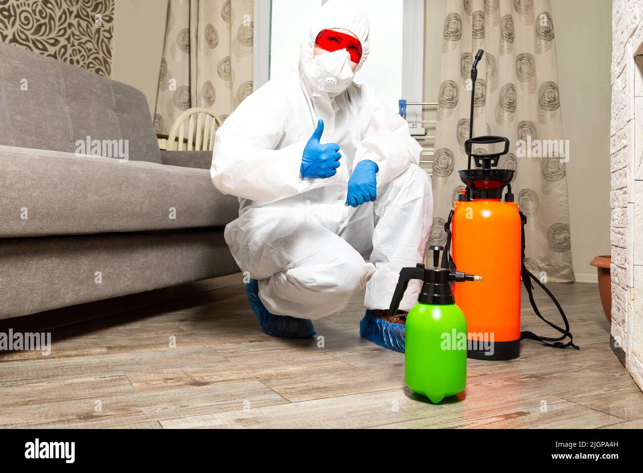 The exterminator at work gives a thumbs up. Fight against insects in ...