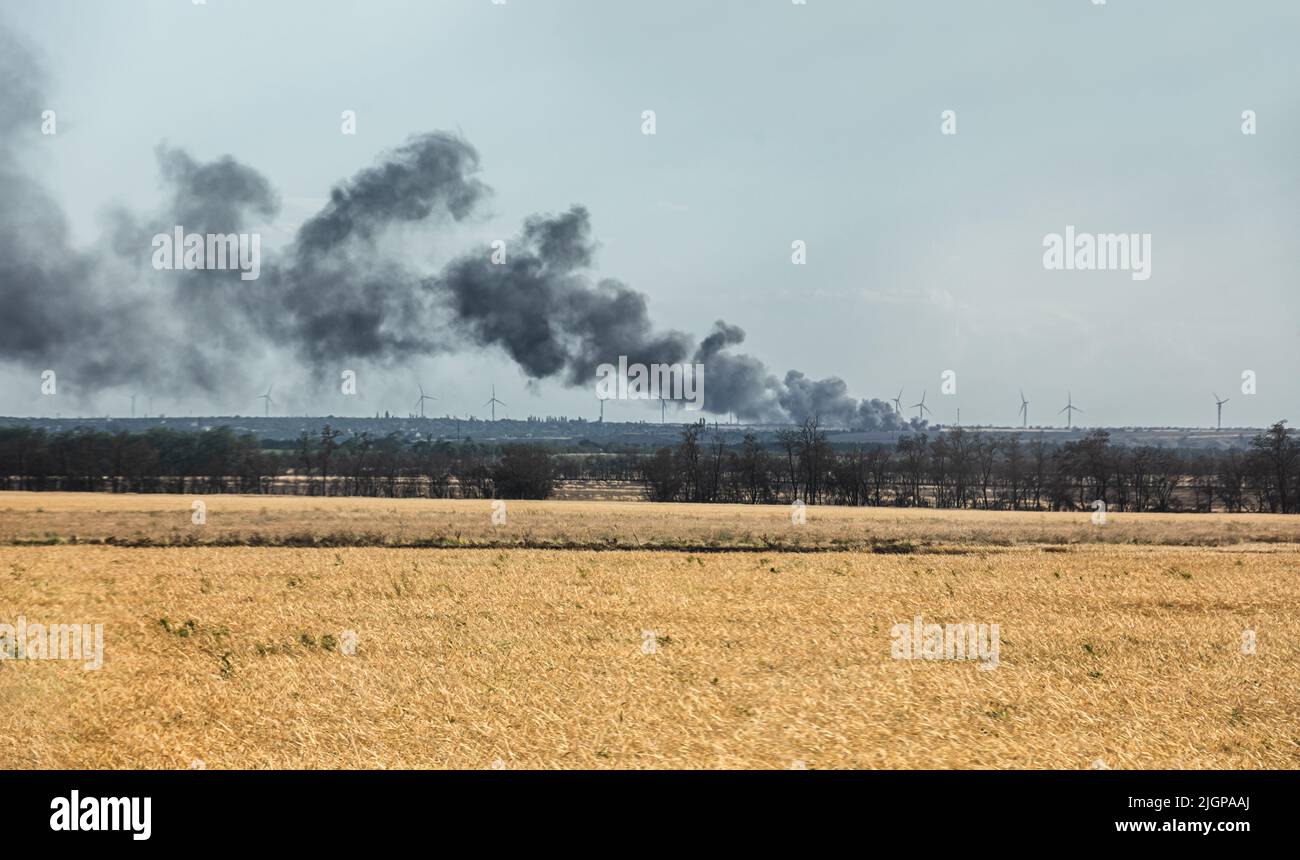 War in Ukraine. Fields of wheat in fire and smoke in the southern ...