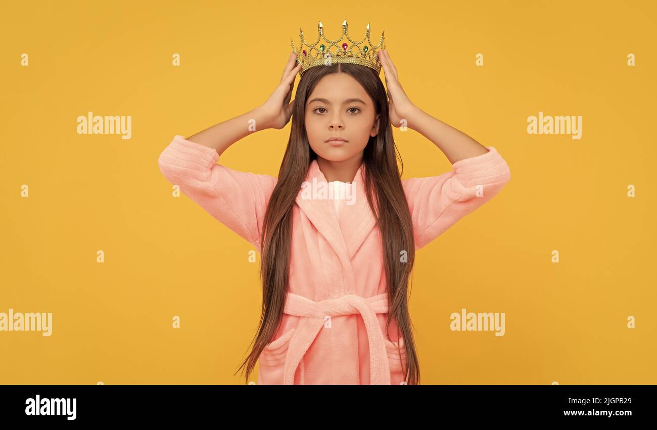 arrogant teen girl in home terry bathrobe and princess crown, arrogance ...