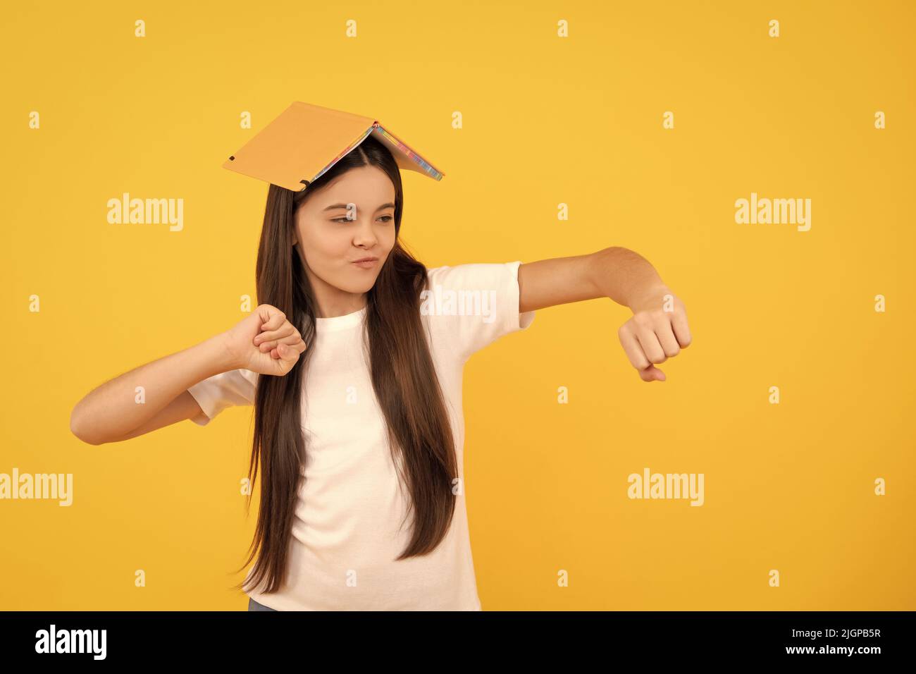 kid dancing with book on yellow background, fun Stock Photo - Alamy