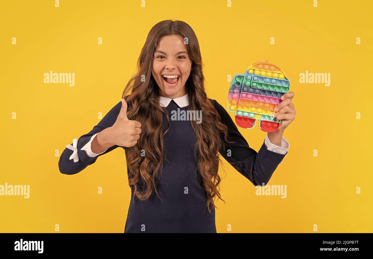 happy child play with popit silicone sensory fidget toy show thumb up ...