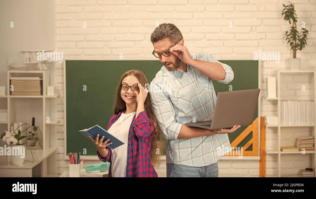 happy father and child study at school with book and laptop on ...