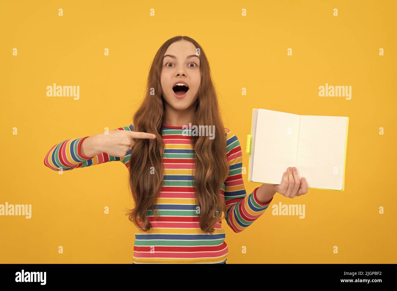 Take a look read a book. Surprised girl point finger at open book. Read ...