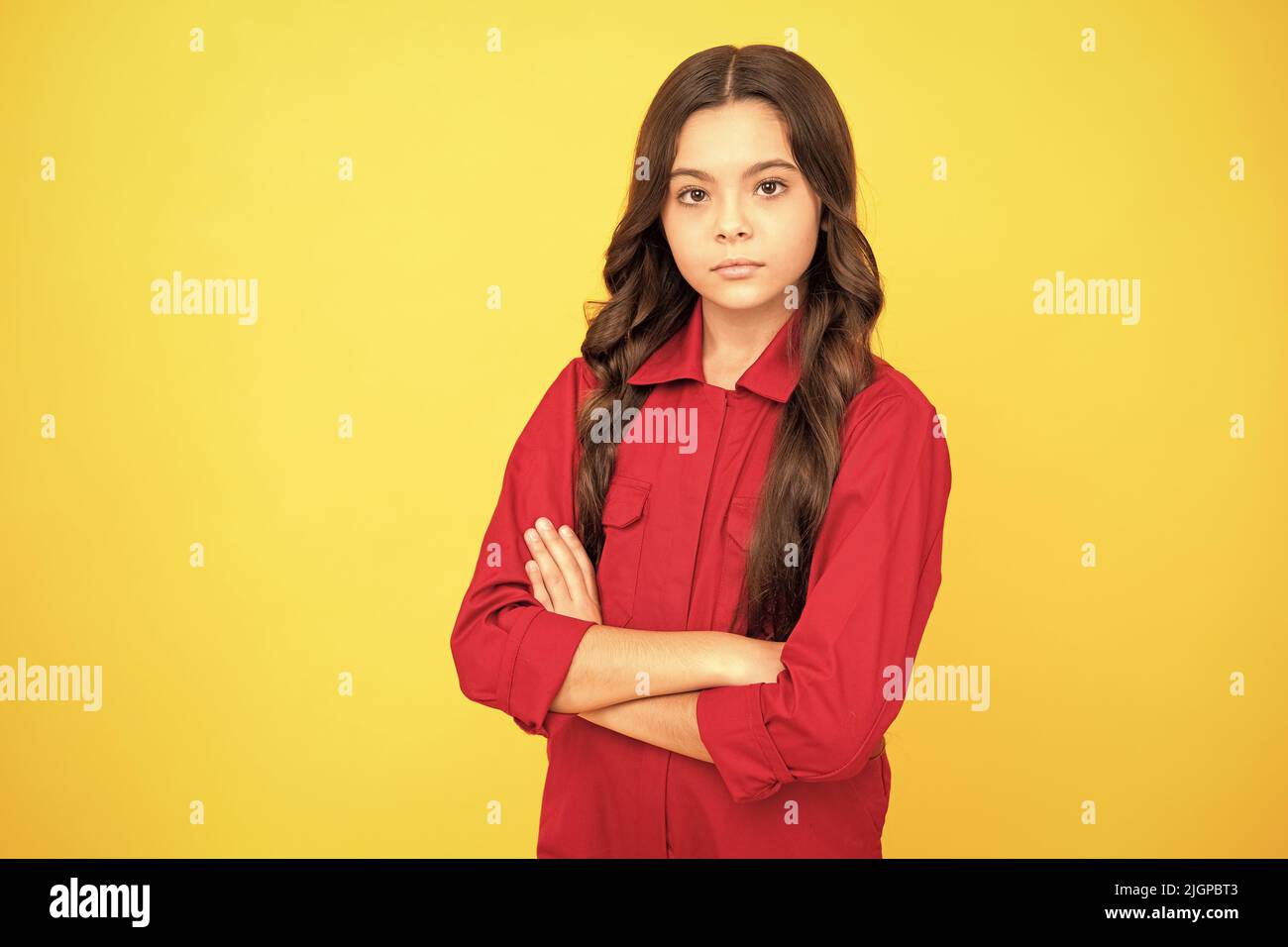 serious child girl with crossed hands looking confident, confidence ...