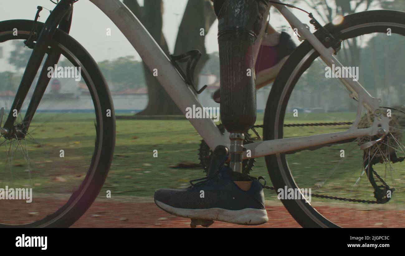 Athletic disabled man with prosthetic leg riding bicycle outside Stock ...