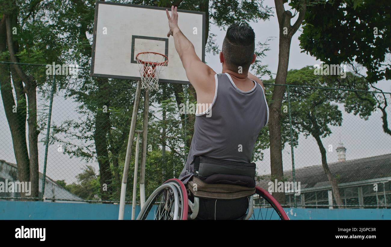 A disabled athlete on wheelchair training basketball. A paraplegic ...