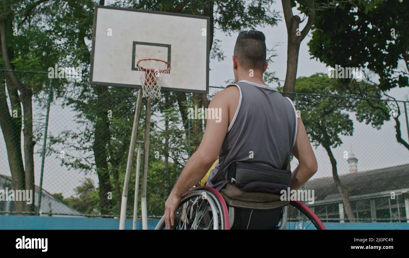 A disabled athlete on wheelchair training basketball. A paraplegic ...