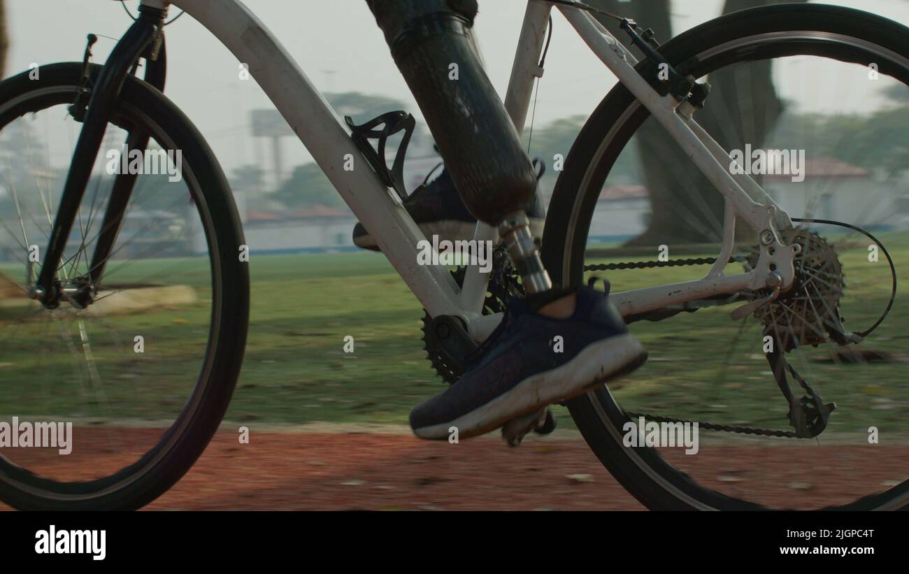 Athletic disabled man with prosthetic leg riding bicycle outside Stock ...