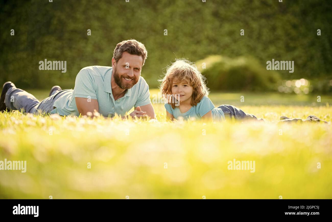 happy family of father and son boy relax in summer park green grass ...
