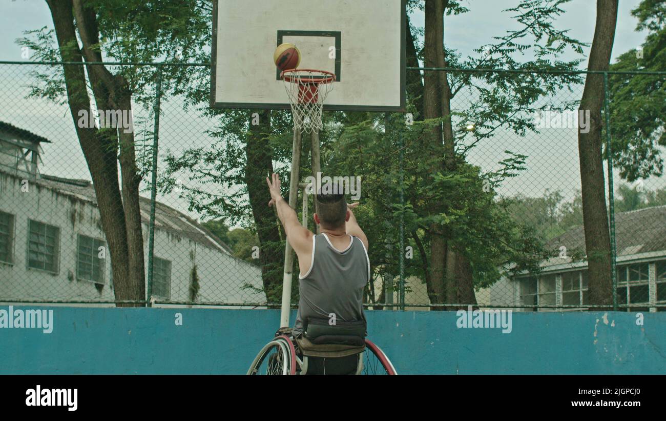 One paraplegic basketball player missing ball hoop outside ...