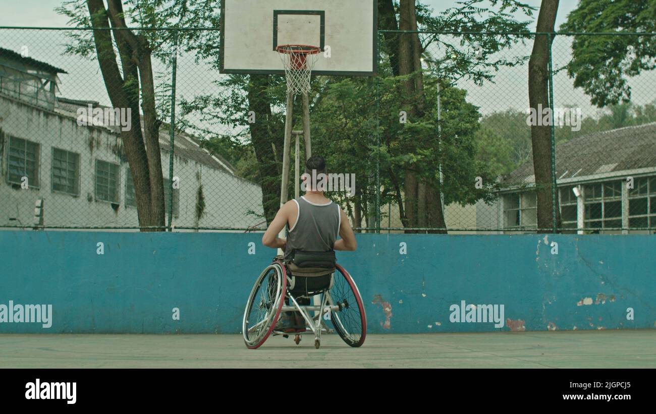 One paraplegic basketball player missing ball hoop outside ...