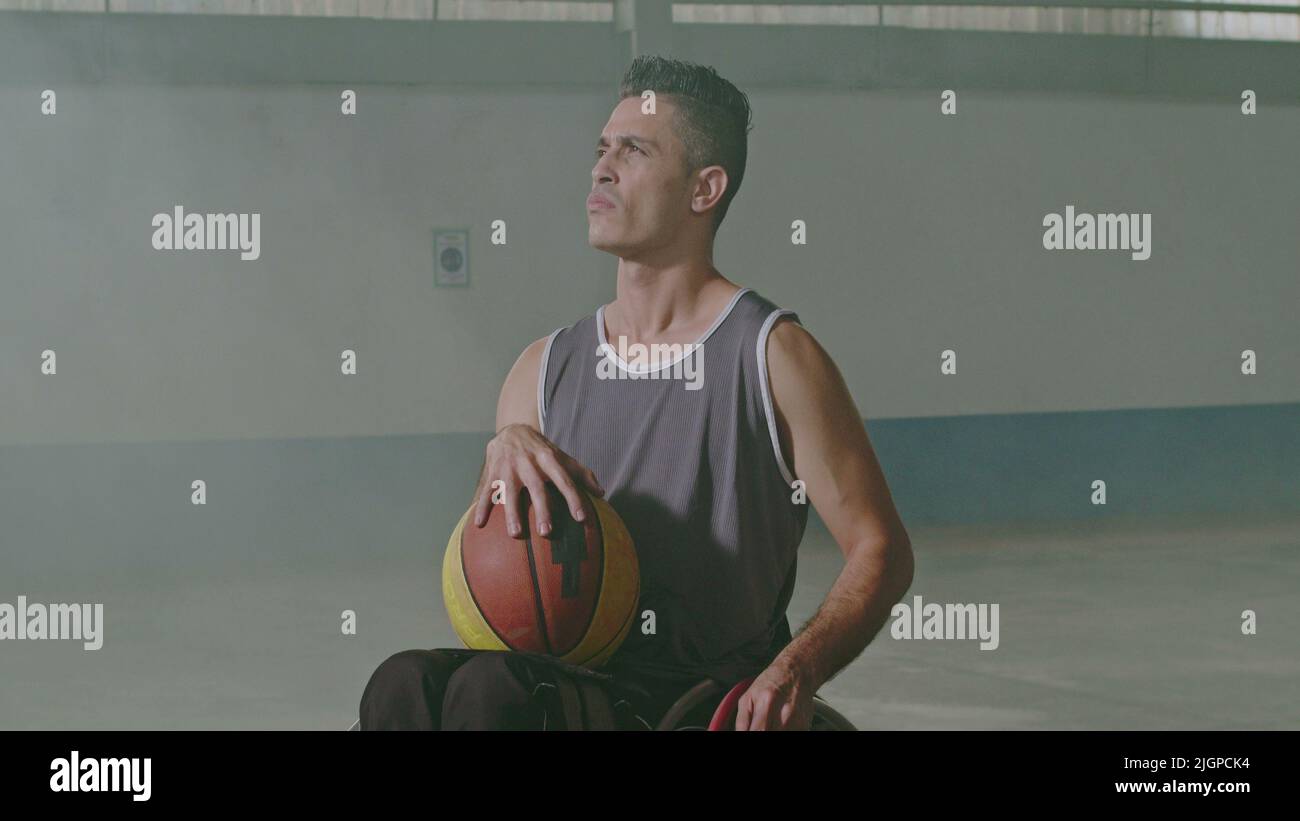 One hispanic disabled basketball player athlete on wheelchair holding ...