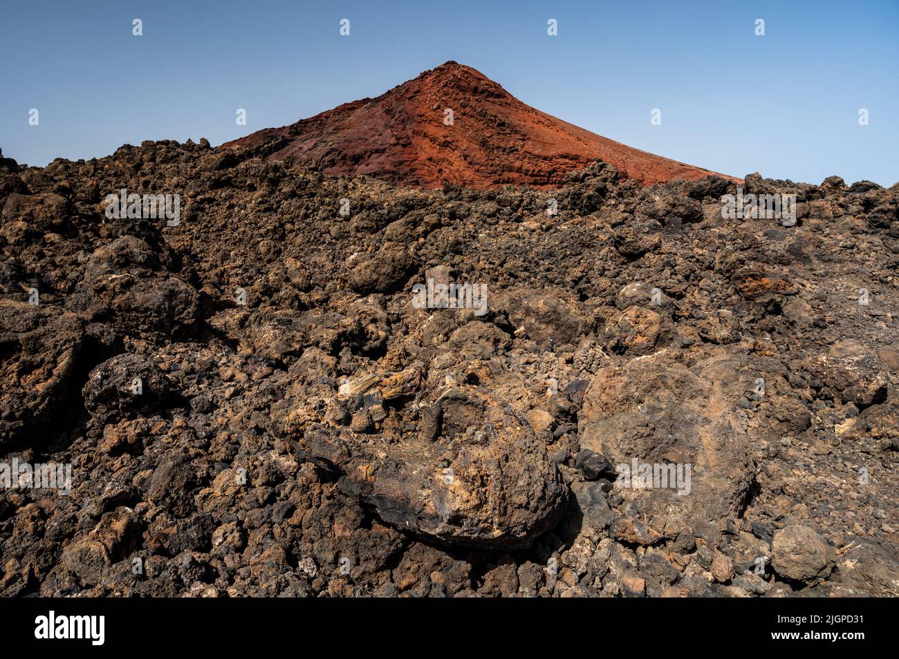 Volcanic rocks formed from lava and a crater of a volcano is seen in ...