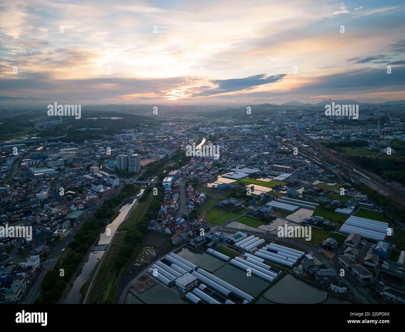 River separates suburban sprawl from rural farming area at sunrise ...