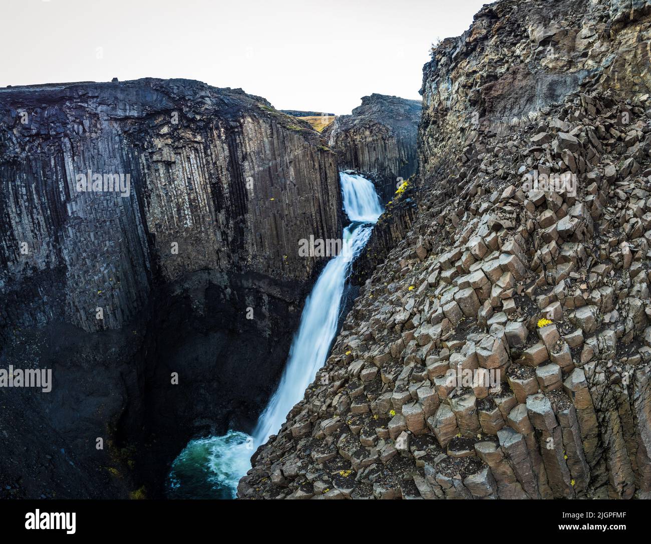 Waterfall in the middle of basalt rocks canyon Stock Photo - Alamy