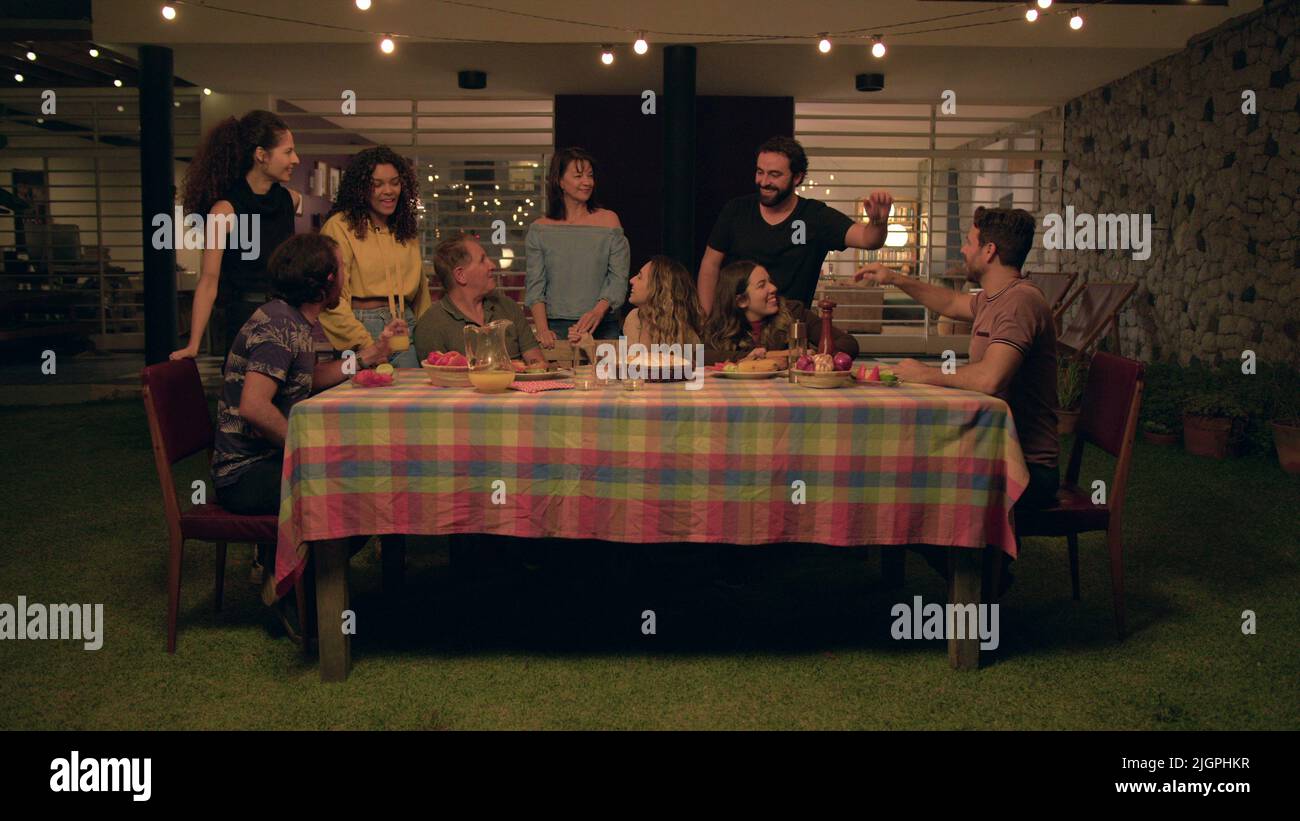 Friends and family united together around table in home backyard ...