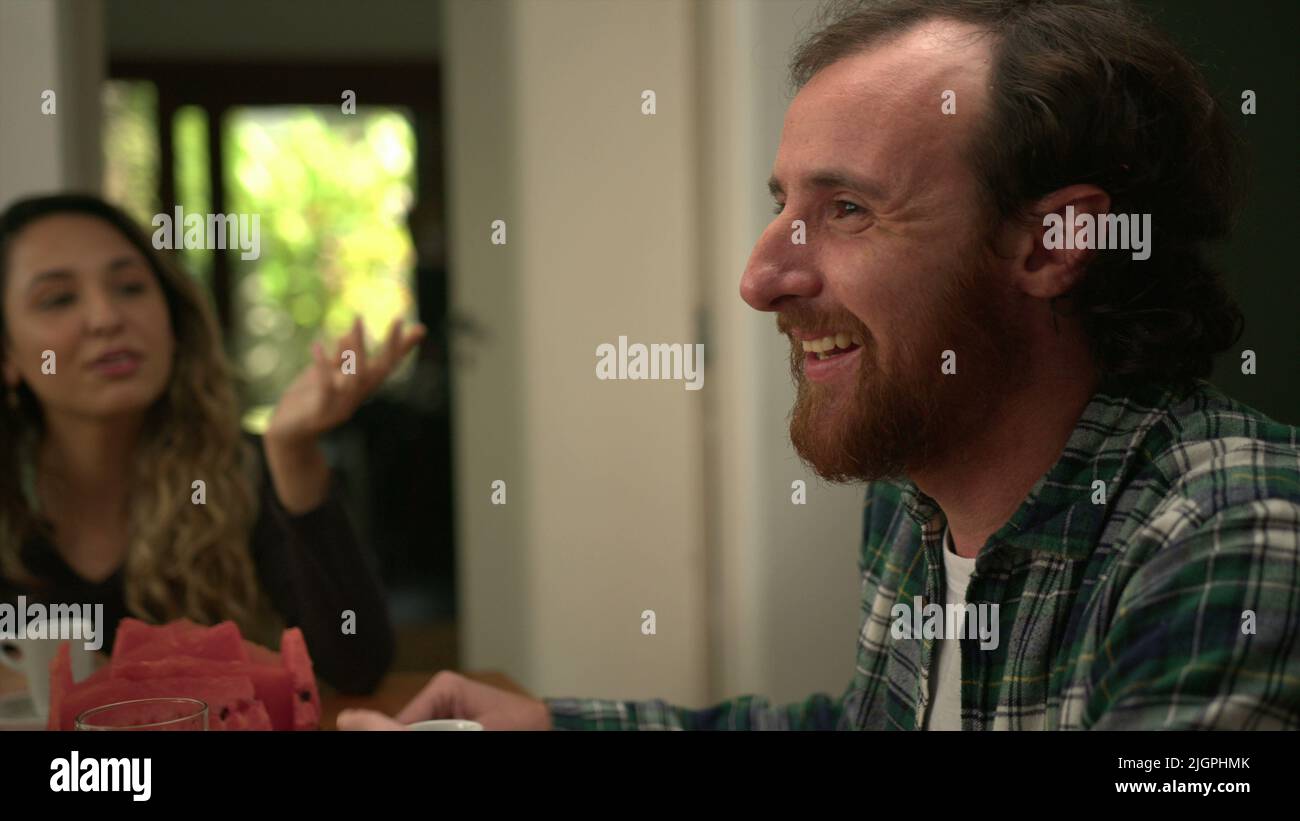 Family together at breakfast morning table in conversation. People ...